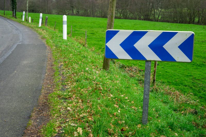 Road and Road Sign Warning about a Turn in the Road. Road Safety ...