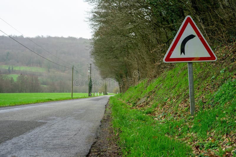 Road and Road Sign Warning about a Turn in the Road. Road Safety ...