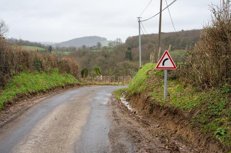 Road and Road Sign Warning about a Turn in the Road. Road Safety ...