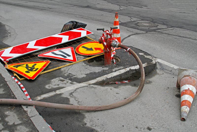 Road Signs, Traffic Cones and Red Fire Hydrant with Hose Stock Photo ...