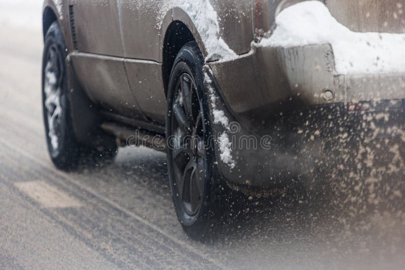 Road Snow Pieces Flow from Wheels of Dirty Car Accelerating in Daylight ...