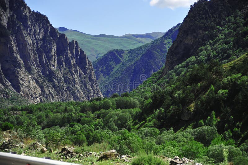 The Road is Squeezed between Steep Cliffs in the Baksan Gorge. Stock ...