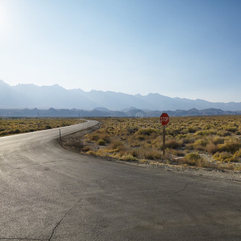 Road with Stop Sign in Barren Landscape. Stock Photo - Image of ...