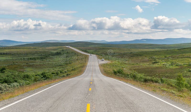 The Road Stretches into the Distance on a Background of Green Meadows ...