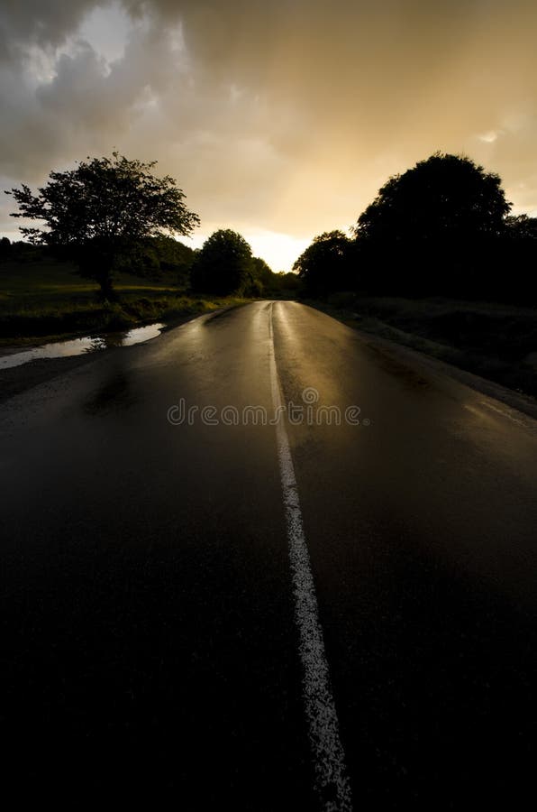 Road at sunset after rain stock image. Image of exploration - 56401099