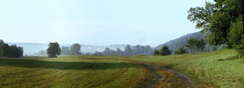 The Road To a Green Open Field with Bushes Stock Image - Image of haze ...