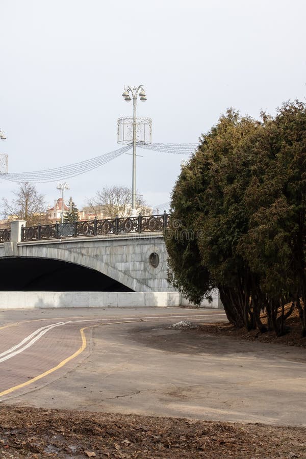 A Road with Trees in the Foreground and a Bridge in the Back Stock ...