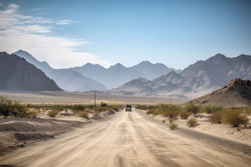 Road Trip on a Dusty Desert Road, with Mountains in the Background ...