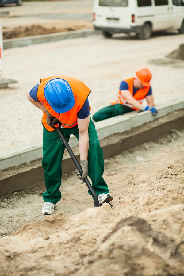Man Digging at Road Construction Stock Image - Image of asphalt ...