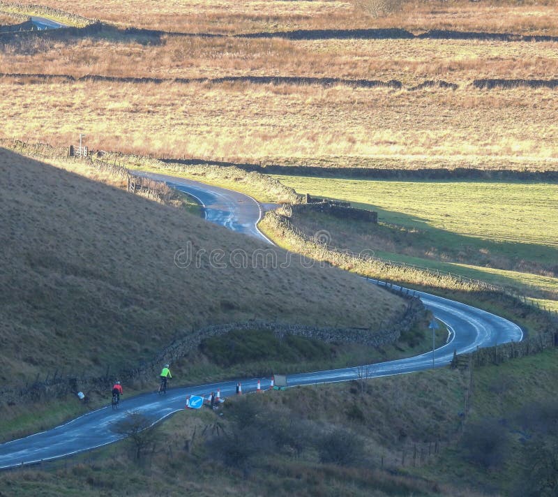 Road Up Dry Hills with Bikers Cycling on it Stock Photo - Image of ...