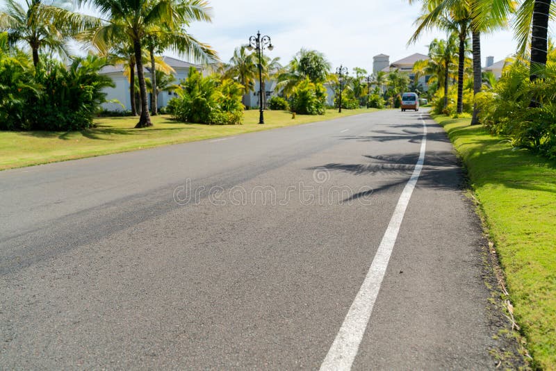 Road in Vacation Resort with Green Trees, Grass and Early Sunlight ...