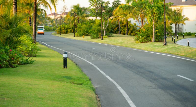 Road in Vacation Resort with Green Trees, Grass and Early Sunlight ...