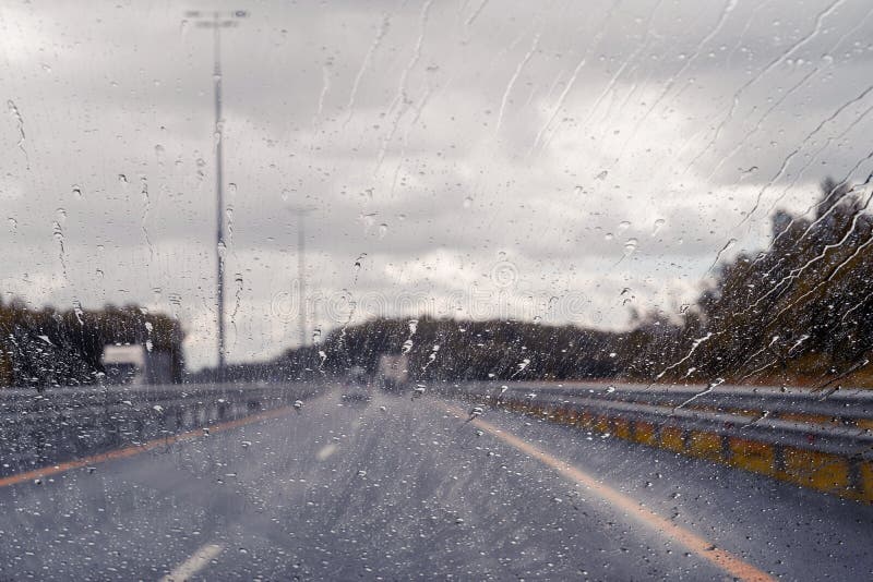 Road View through Windshield Car Window with Going Rain Drops during ...