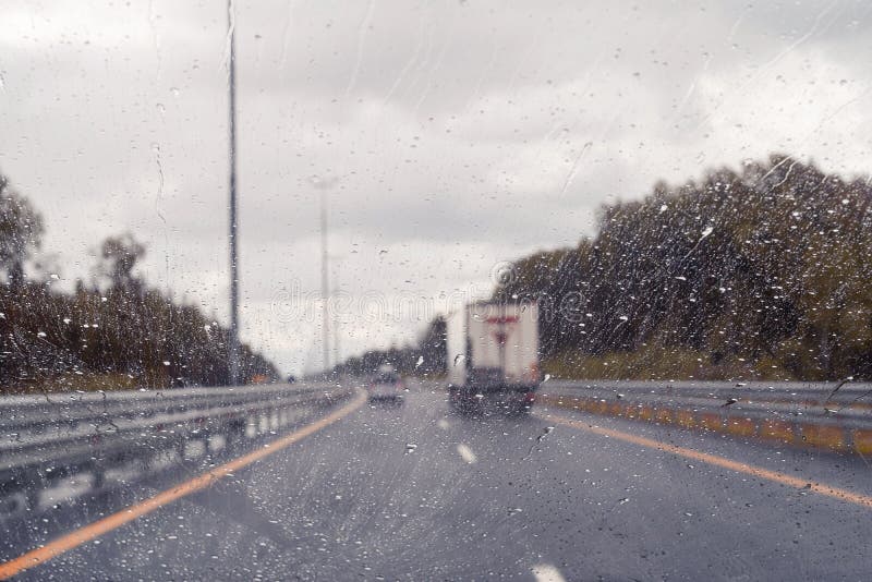 Road View through Windshield Car Window with Going Rain Drops during ...