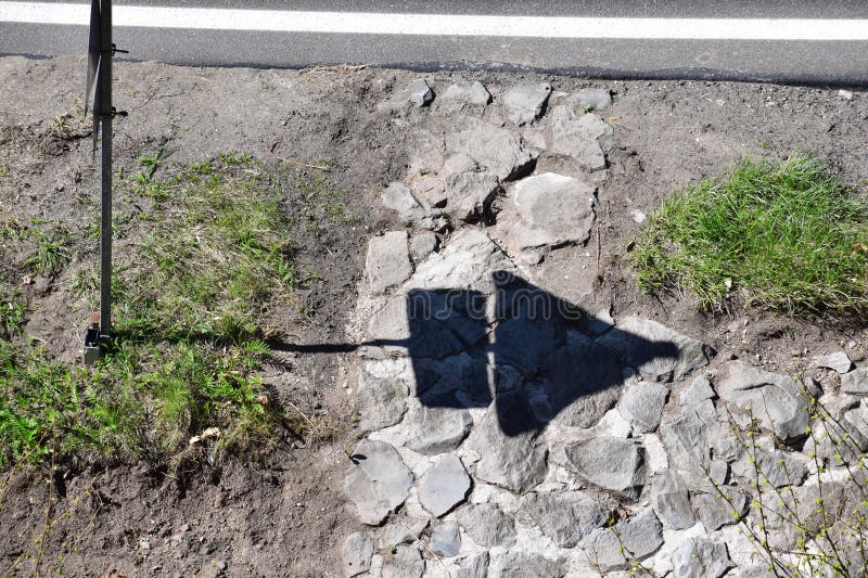 Shadow of a Triangle Shaped Sign Stock Image - Image of traffic, wall ...