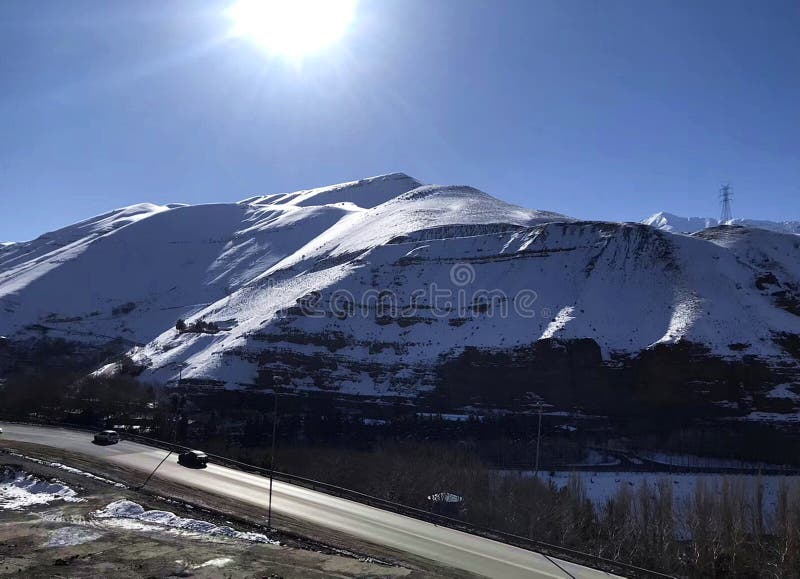 Road and White Snow Mountains in Bright Sunny Day Stock Photo - Image ...