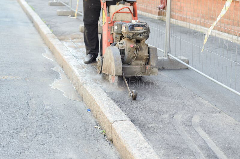 Road Worker Cutting Asphalt Road Using Cutting Machine with Diamond Saw ...