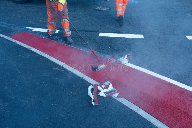 Road Workers Applying Hot Red Road Marking Paint on New Build Road ...