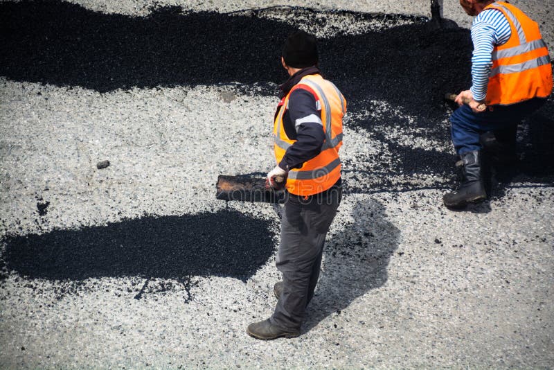 Road Workers are Repairing Section of Asphalt Road. Editorial Photo ...