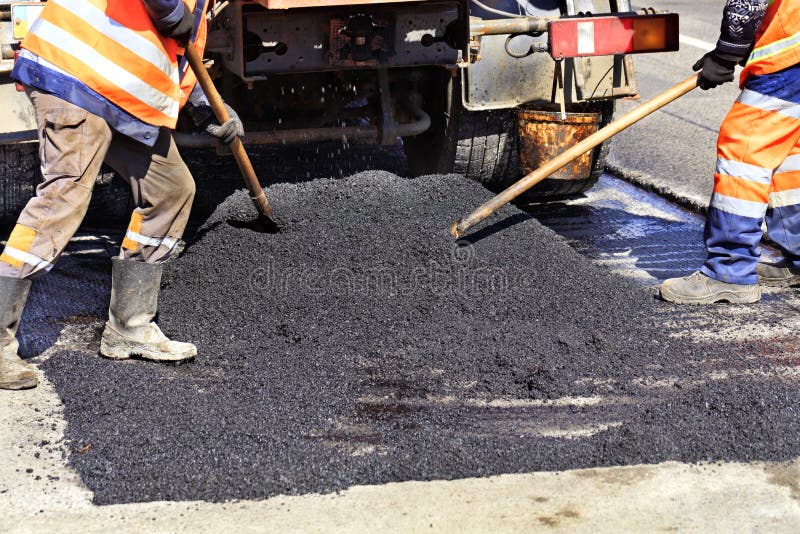 The Working Crew Evenly Distributes Hot Asphalt with Shovels Manually ...