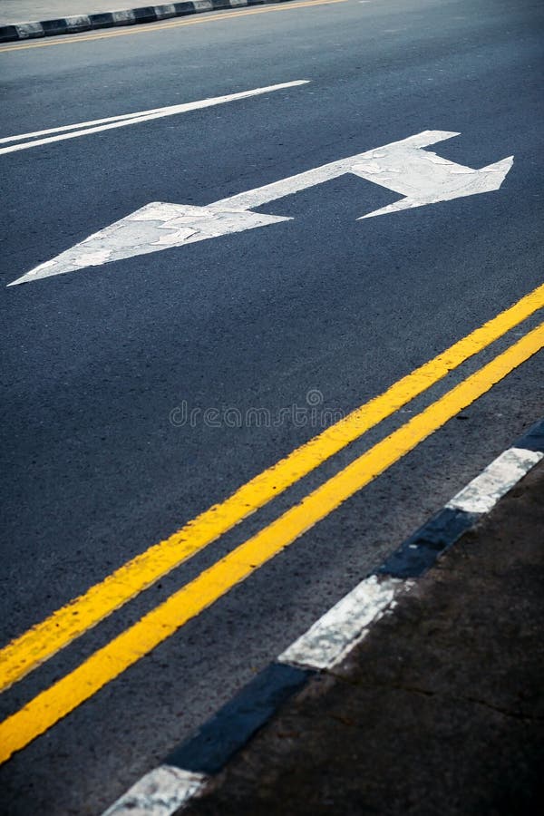 Road with Yellow Lines and White Arrows Stock Photo - Image of travel ...