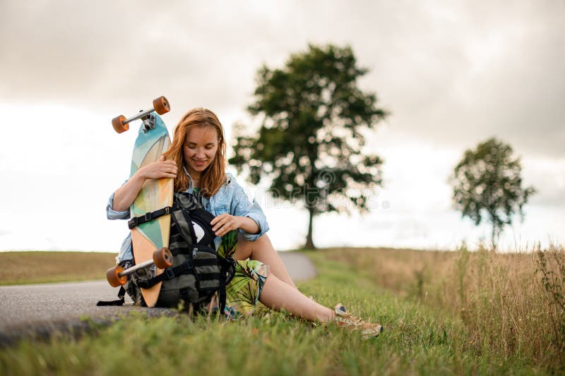 Roadside Break. Girl with Longboard, Backpack, Taking a Quiet Pause ...