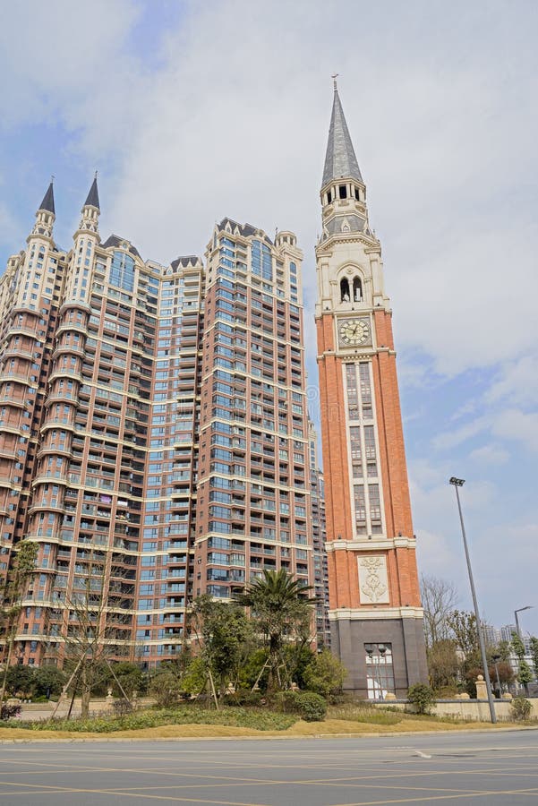 Roadside Clock Tower and Modern Building with Steeples in Cloudy Stock ...