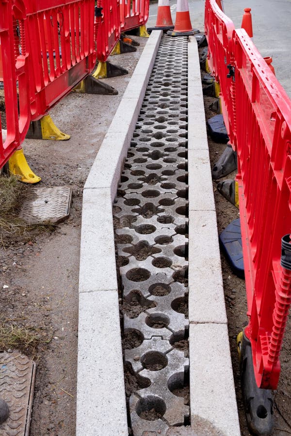 Roadside Kerb Being Constructed On A Grass Verge With Grass Guard