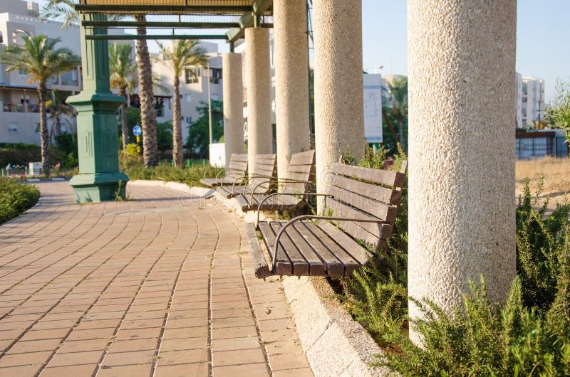 Roadside Patio of Columns and Benches Stock Image - Image of wooden ...