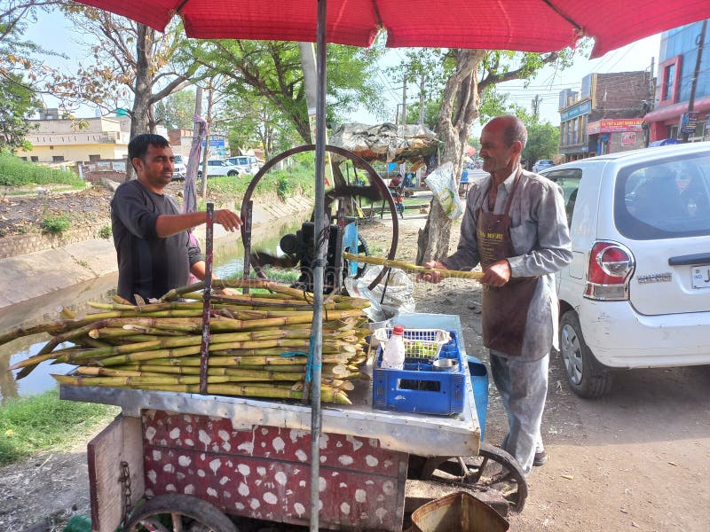 Roadside Stall for Extracting and Selling Sugarcane Juice in India ...