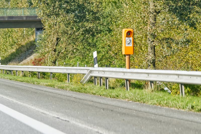 A Roadside View Featuring a Speed Camera Mounted on an Orange Pole ...