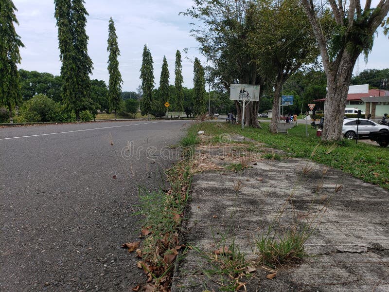 Roadside View with Trees, Grass, and a Helmet Sign Editorial Image ...