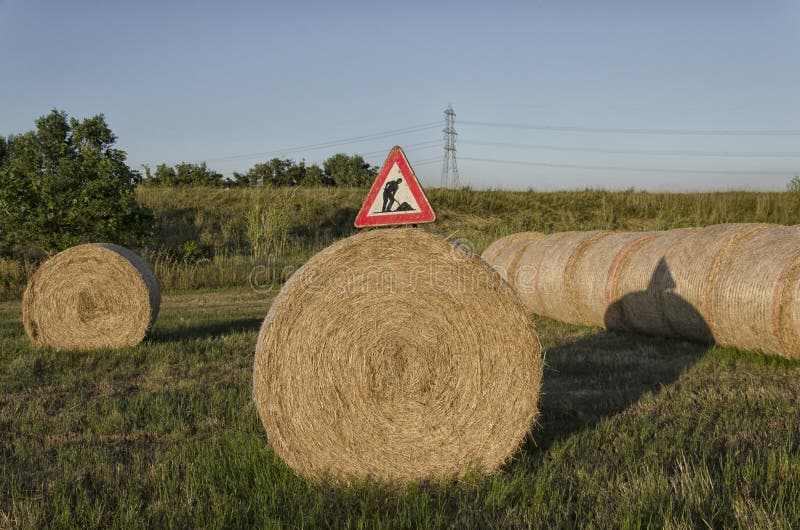 Roadsign Over Straw Round Bale Stock Photo - Image of triangle ...