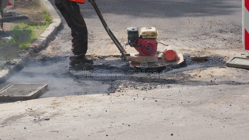 Roadworks Construction Worker Using Ground Plate Compactor Flattening ...