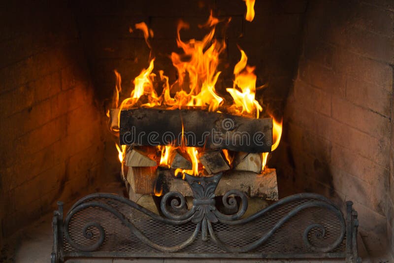 A Roaring Fire within a Large Stone Arched Fireplace. Stock Image ...
