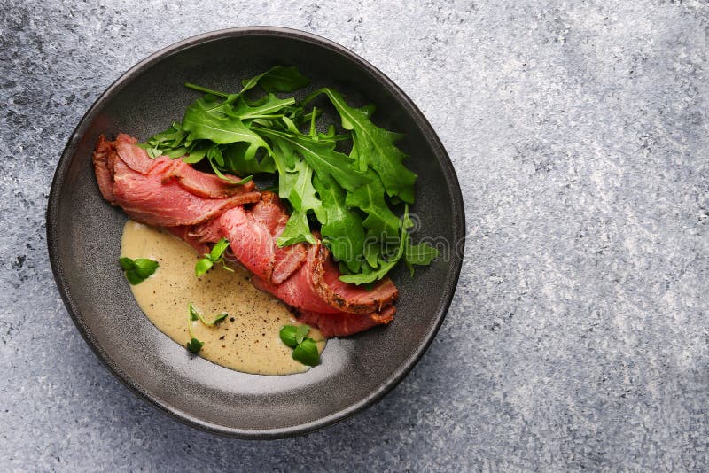 Roast Beef with Arugula Closeup. Roast Beef Slice Top View on Light ...