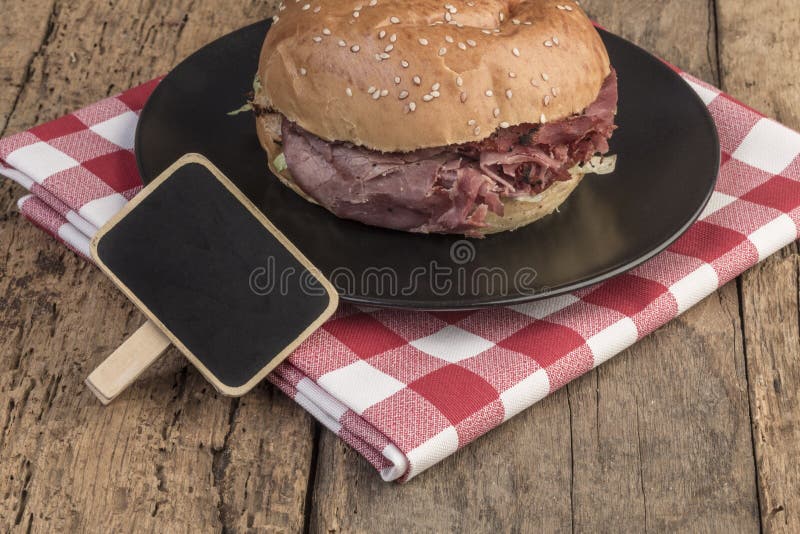 Roast Beef Burger and a Chalkboard on Wooden Table Stock Photo - Image ...