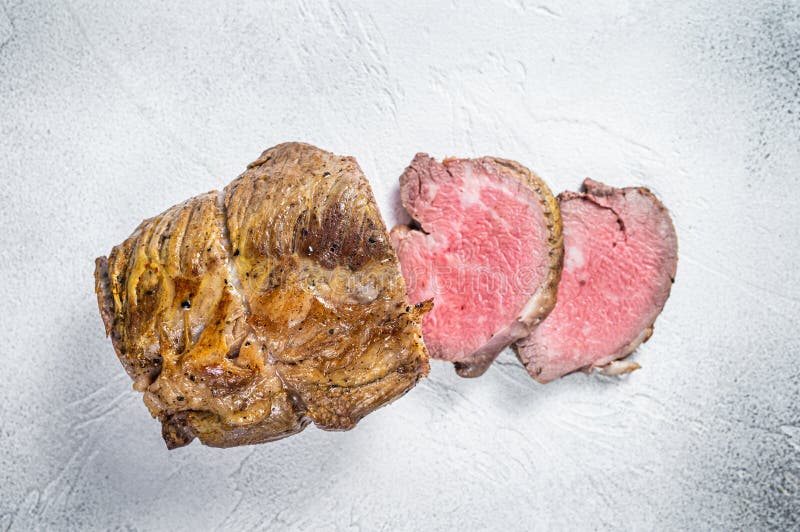 Roast Beef Meat Fillet on Kitchen Table. White Background Stock Photo ...