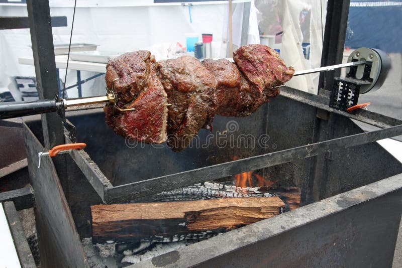 Roast Beef on Outdoor Rotisserie Stock Photo - Image of flames ...