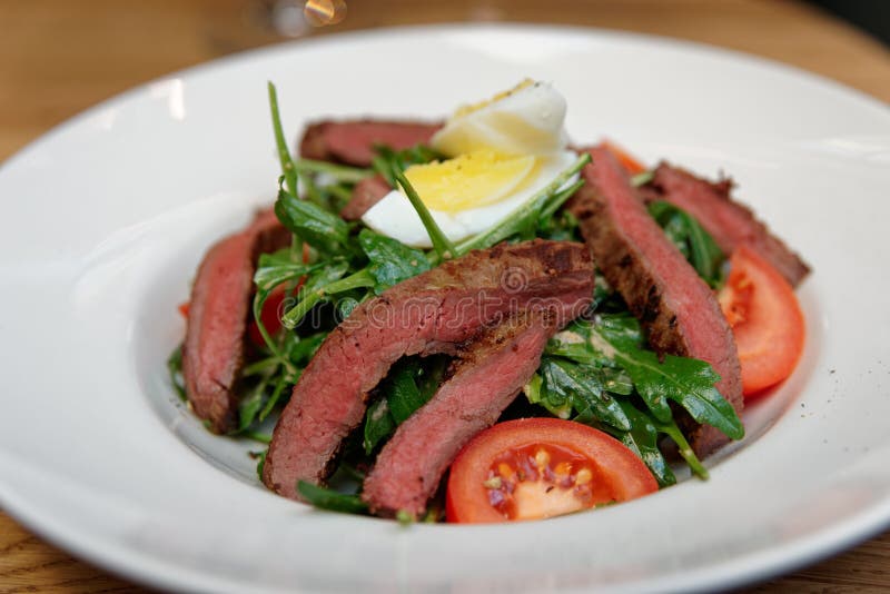 Roast Beef Starter with Arugula and Eggs on White Plate Stock Image ...