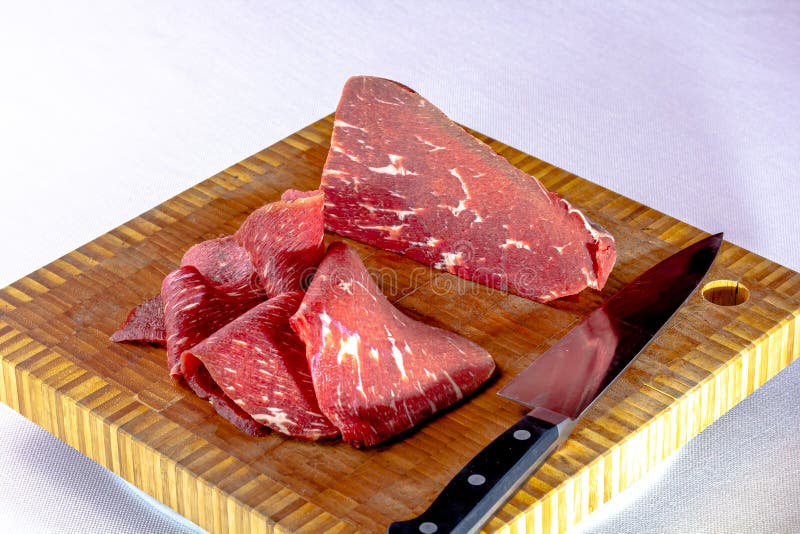 Roast Beef. Thin Slices of Raw Marbled Beef Lie on the Board Stock ...