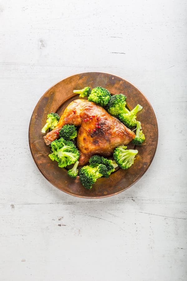 Roast Chicken Leg. Chicken Roasted Leg with Broccoli on Concrete Stock ...