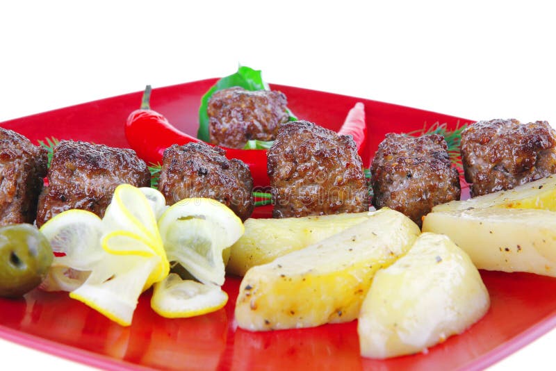 Roast cutlets on red dish stock image. Image of lemon - 16025269