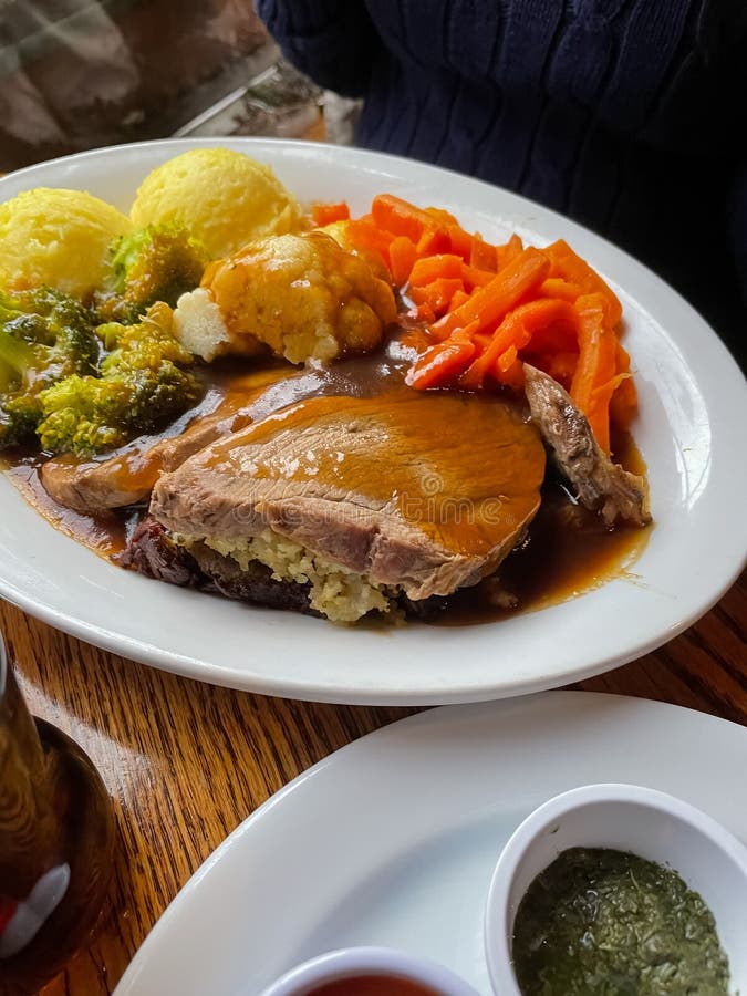 Up-view of a Roast Lamb & Root Veg Dish on a White Dish Plate. Ready To ...
