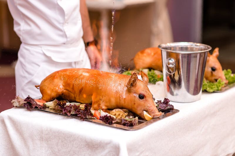Roast Pig. Roasted Piglet with Vegetables on Platter Stock Image ...
