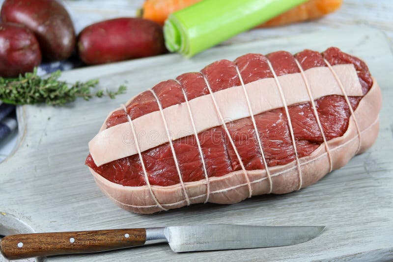 Roast raw beef stock photo. Image of cooking, bard, cutting - 176155016