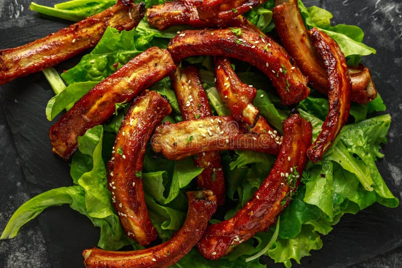 Roasted Barbecue Hot Pork Ribs Served on Stone Board with Vegetable ...