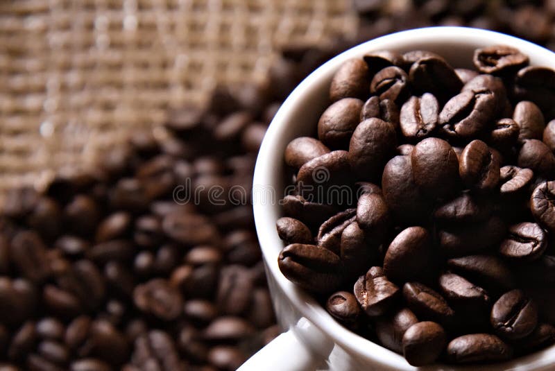 Freshly Brewed Coffee Inside a Coffee Cup and Roasted Coffee Beans on a ...