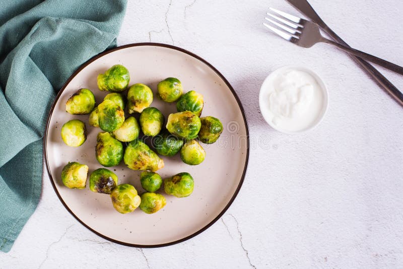 Roasted Brussels Sprouts on a Plate on the Table. Vegetarian Diet Stock ...