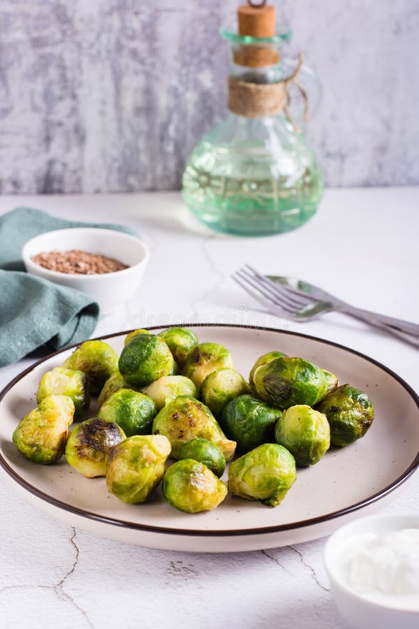 Roasted Brussels Sprouts on a Plate on the Table. Vegetarian Diet Stock ...